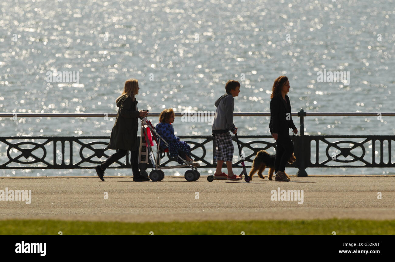 Weather spring. People walk along the seafront in Hove, East Sussex ...