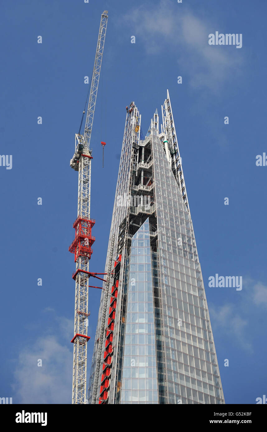 The Shard. Construction workers work at the top of the Shard building ...