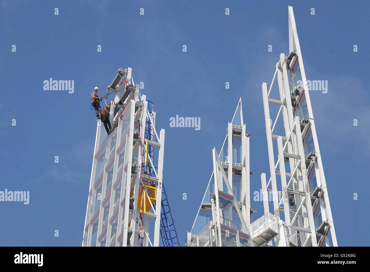 The Shard. Construction workers work at the top of the Shard building ...