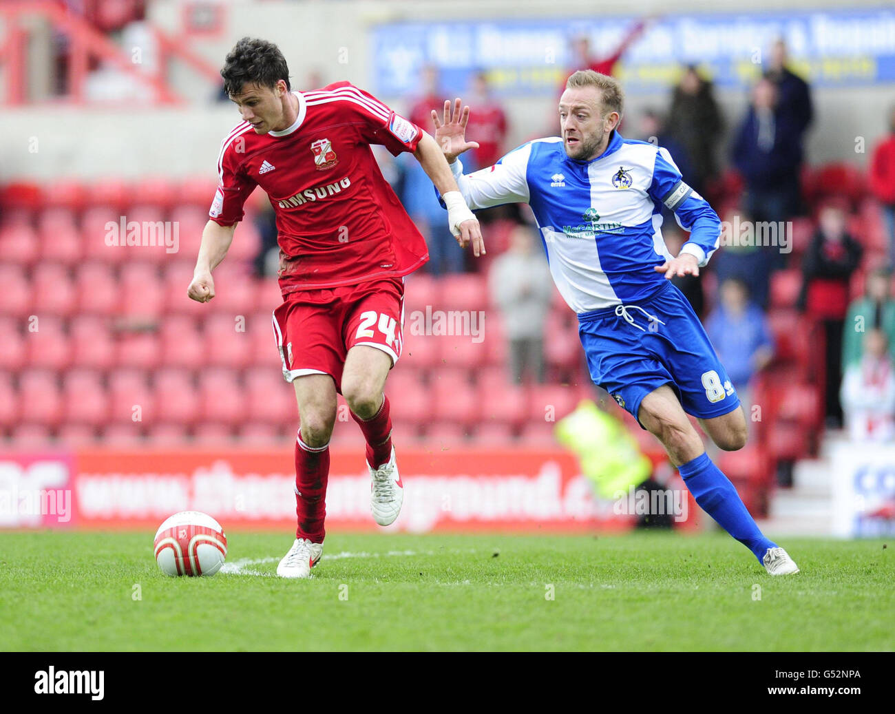 Swindon Town's Jonathan Smith and Bristol Rovers Matt Gill in action ...