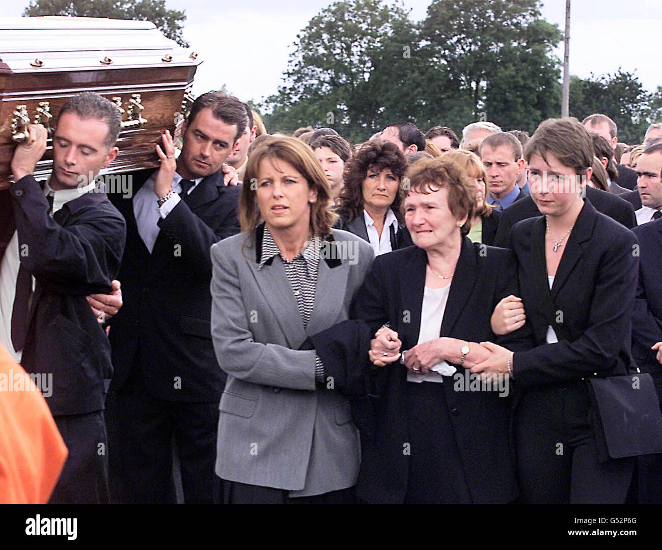 May Dunlop (centre) Joey Dunlops mother is comforted by family as she ...
