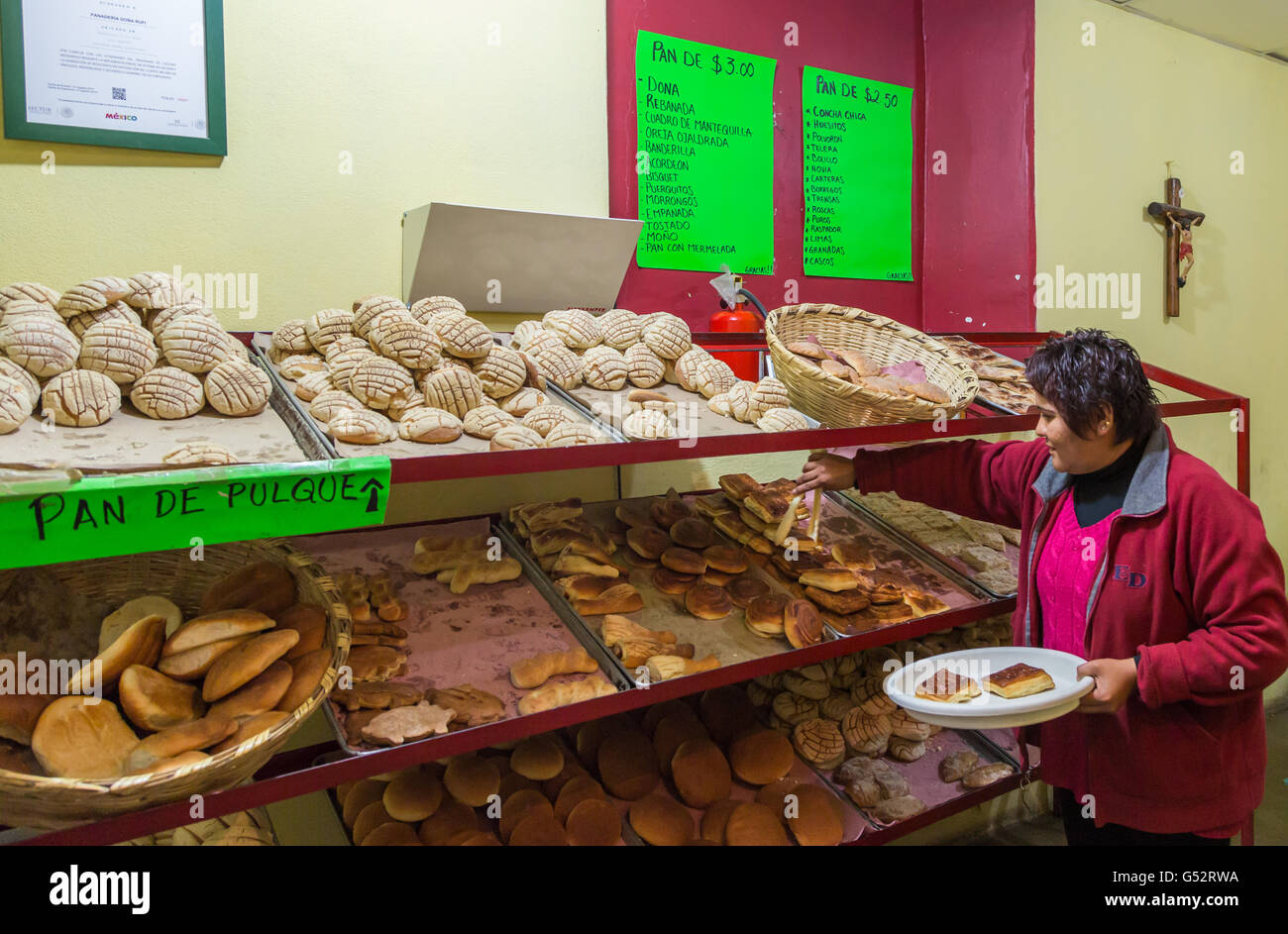 Mexican woman shopping in a panaderia or bread shop in the Sierra Gorda ...