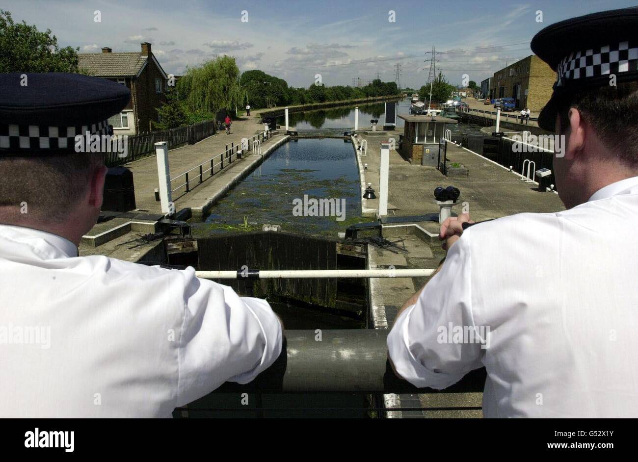 Two policemen over-look Tottenham Lock on the River Lea in Tottenham ...