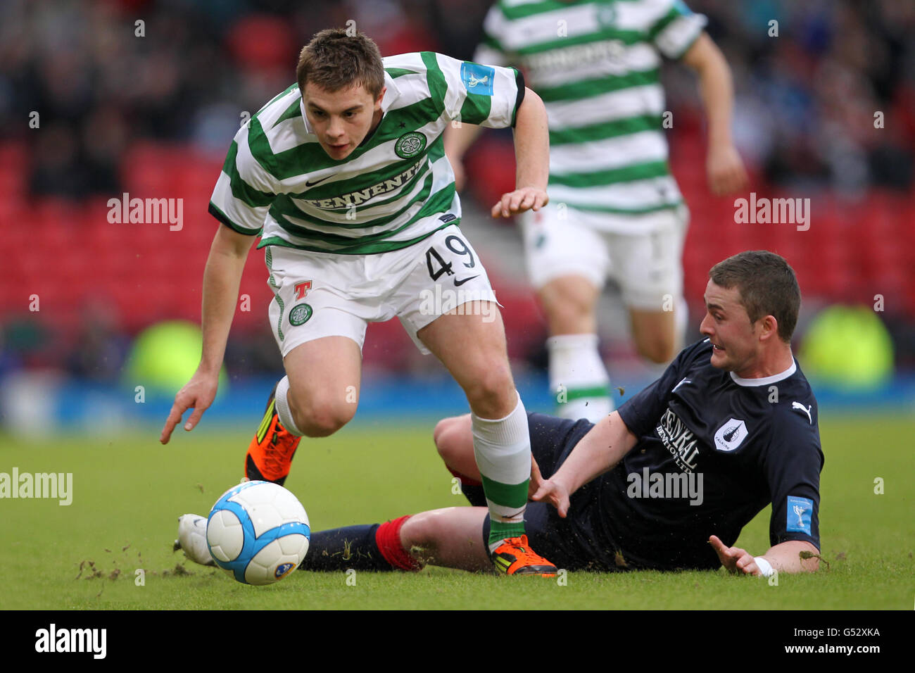 Celtic's James Forrest evades a challenge by Falkirk's Thomas Scobbie ...