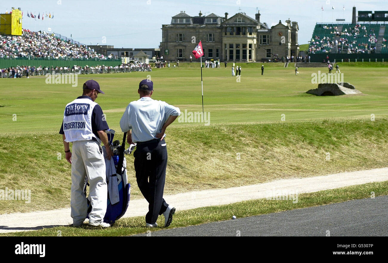 Britain's Dean Robertson discusses with his caddie how he is going to ...