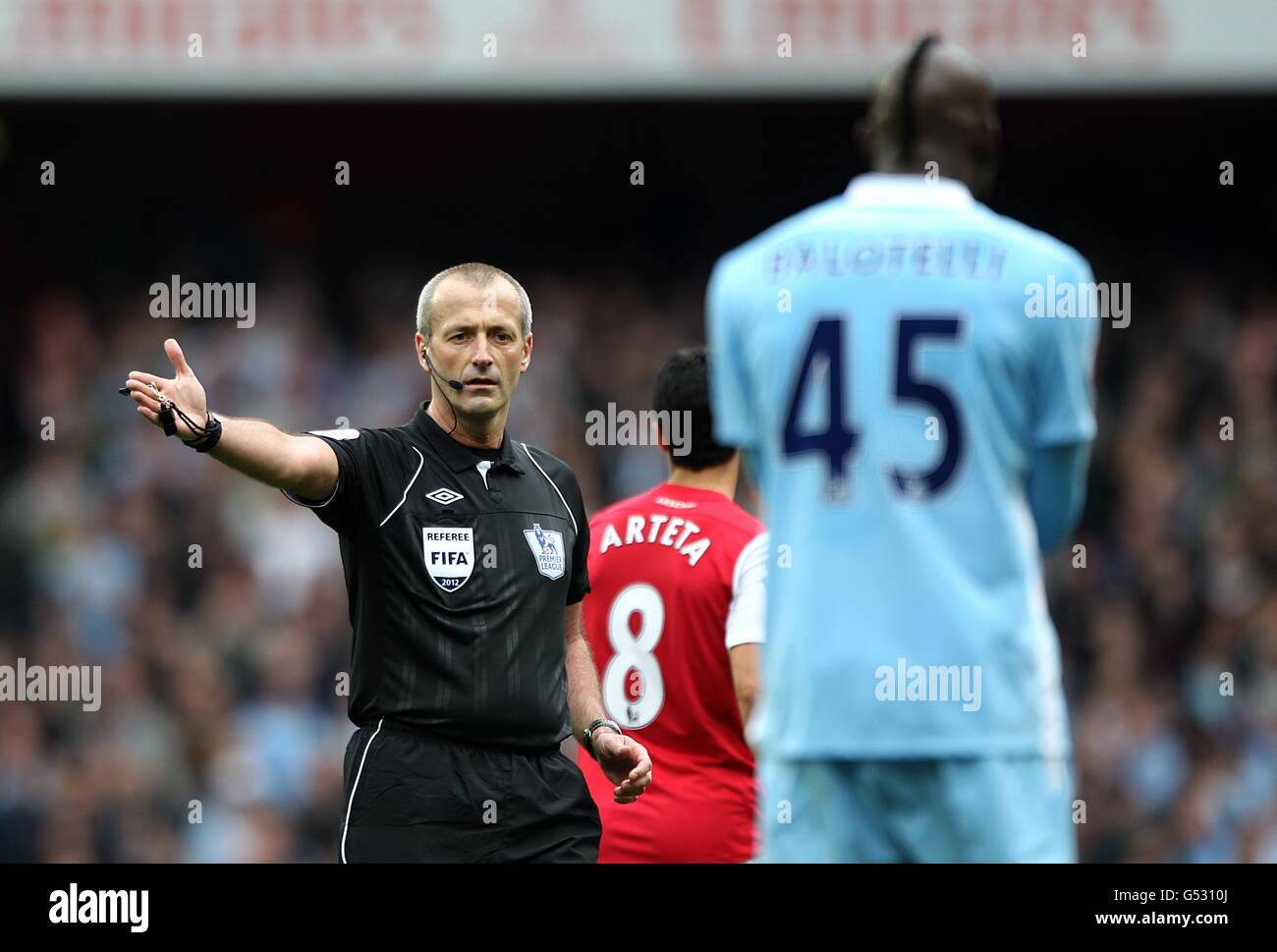 Referee Martin Atkinson (left) with Manchester City's Mario Balotelli ...