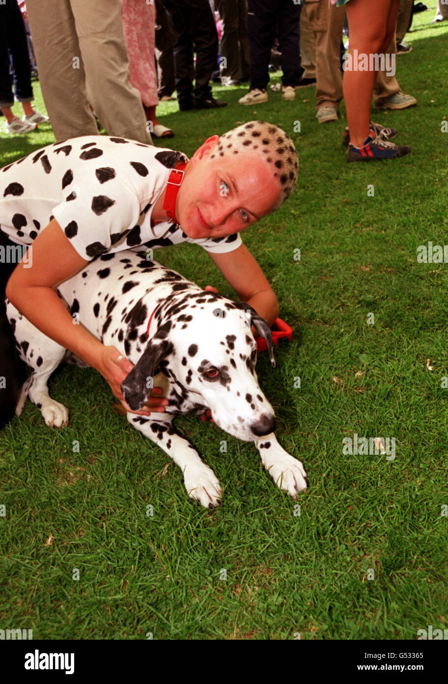 A festival goer and her dog enjoy the sunshine at the 'Pride' in ...