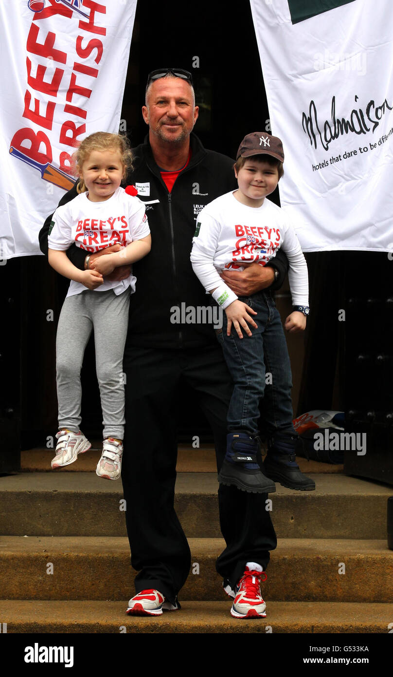 Former cricketer Sir Ian Botham, holds Rebecca Foley, five, who is in ...