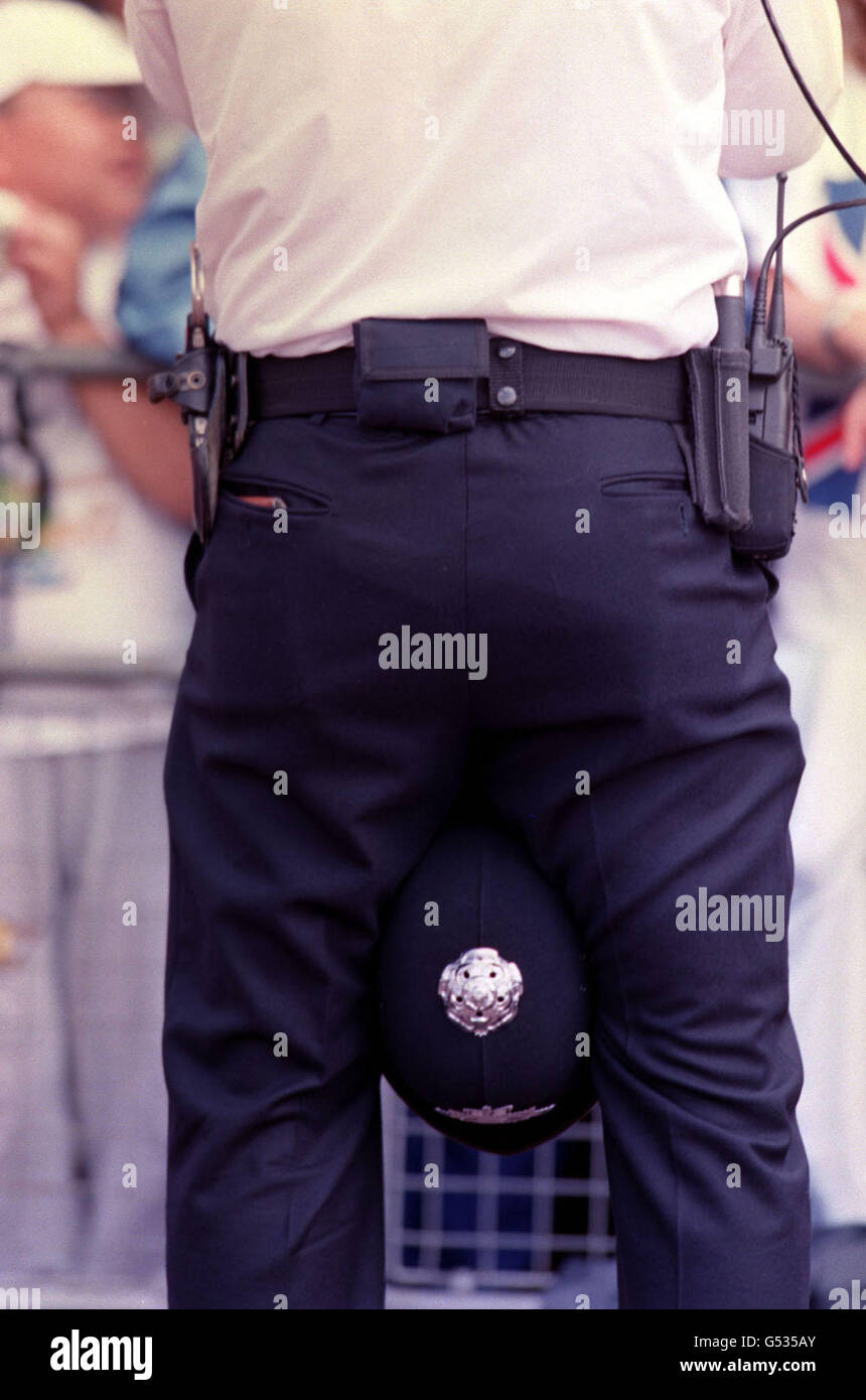 A police officer holds his helmet between his legs outside Buckingham ...