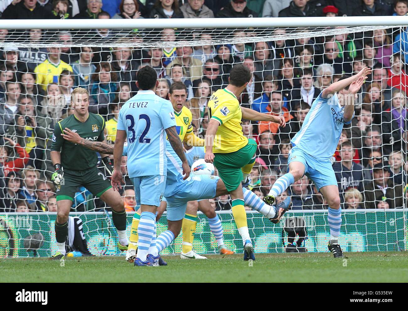 Norwich citys andrew surman centre past the manchester city defence hi ...