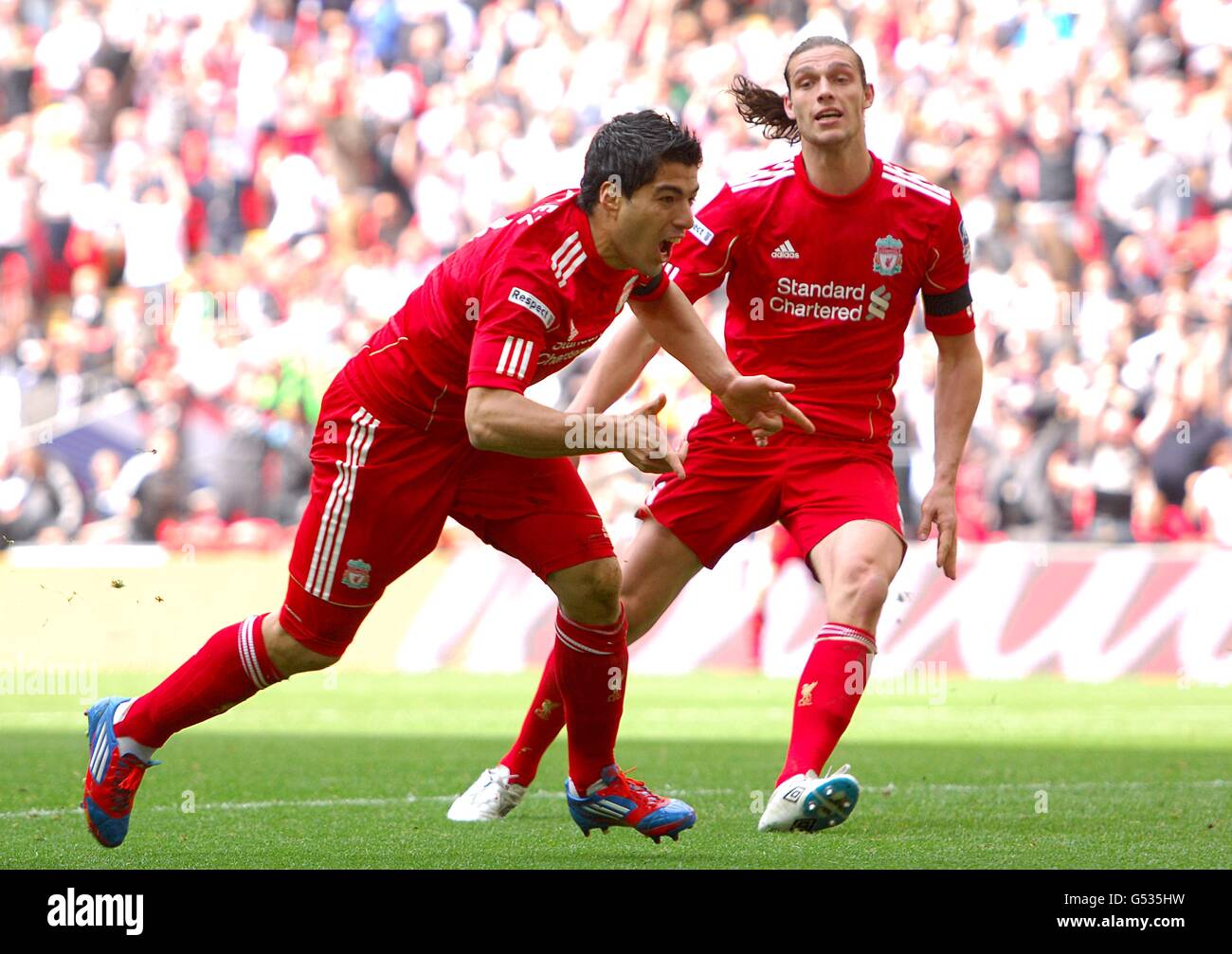Liverpool's Luis Suarez (left) celebrates scoring their first goal of ...