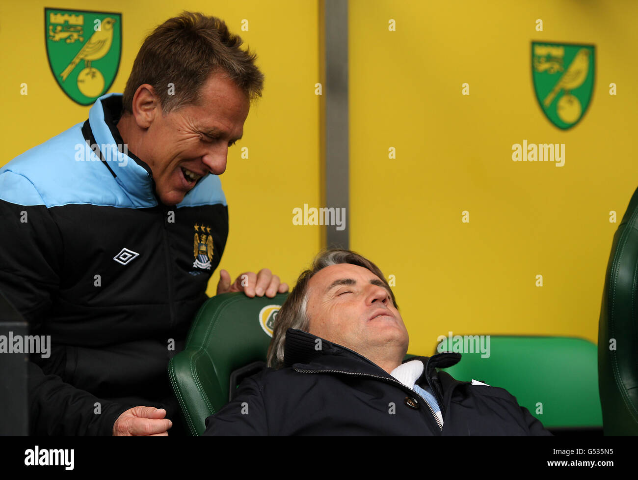 Manchester citys manager roberto mancini relaxes on the team bench hi ...