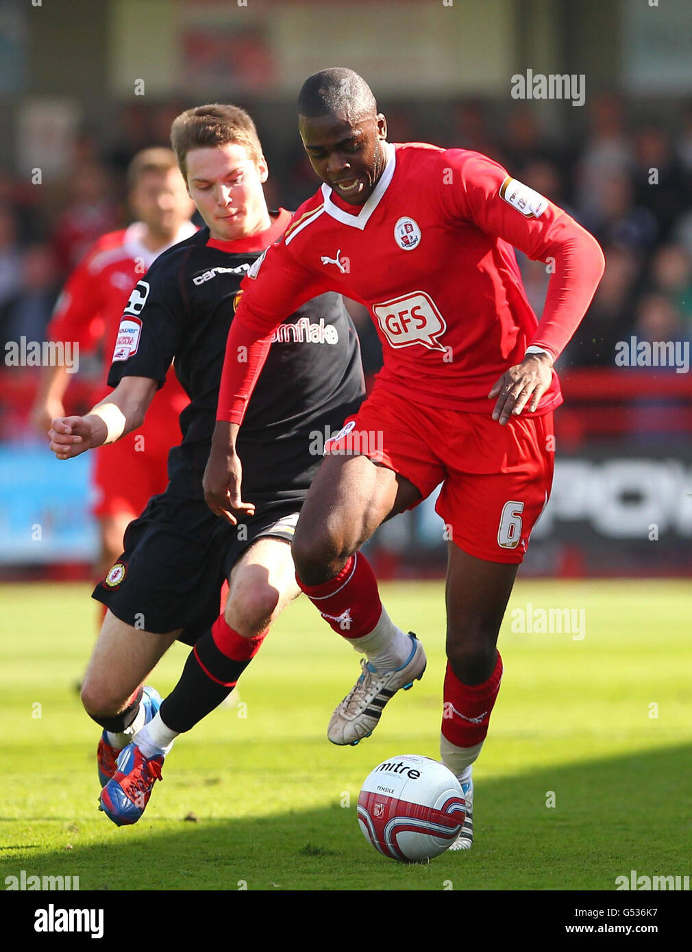 Crawley's Hope Akpan is chased by Crewe's Nick Powell during the npower ...