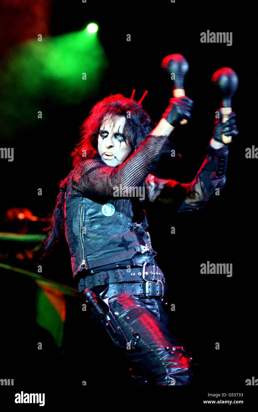 Veteran American metal rock singer Alice Cooper performing with maracas ...