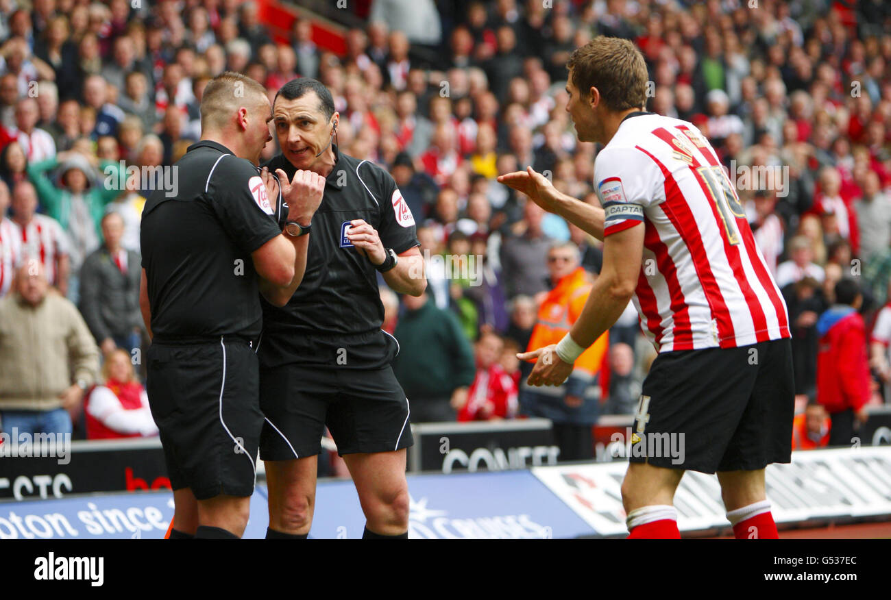 Referee Neil Swarbrick (centre) consults the linesman before awarding ...