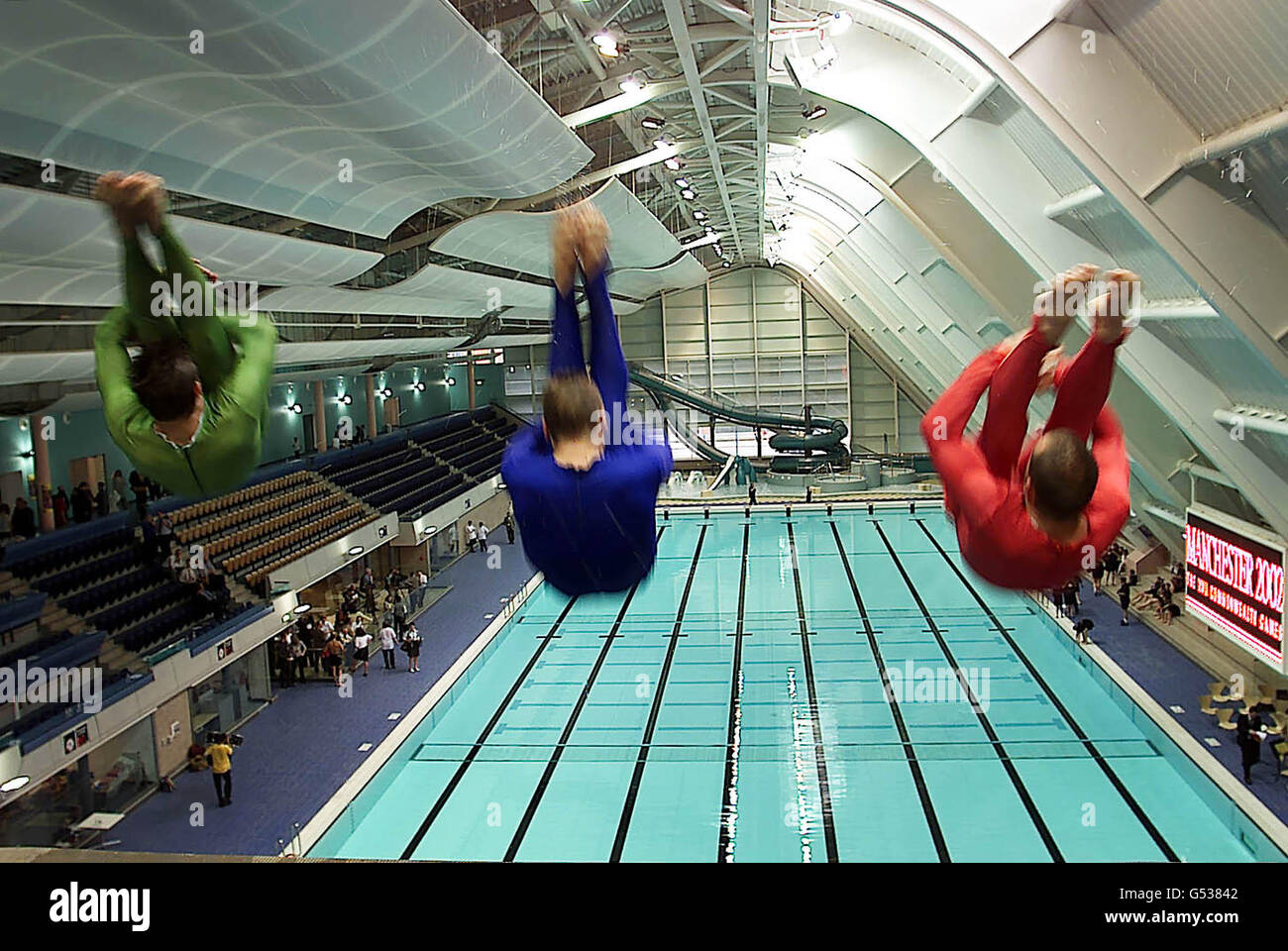 Three divers launch themselves from the high board High Resolution ...