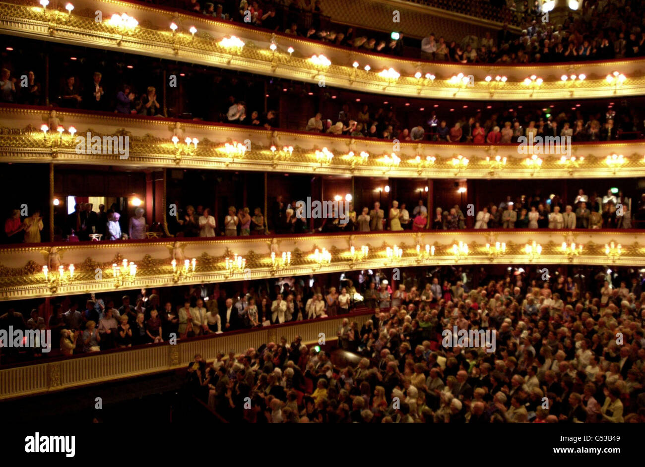 The Queen Mother and The Queen (under spotlight left centre) are ...