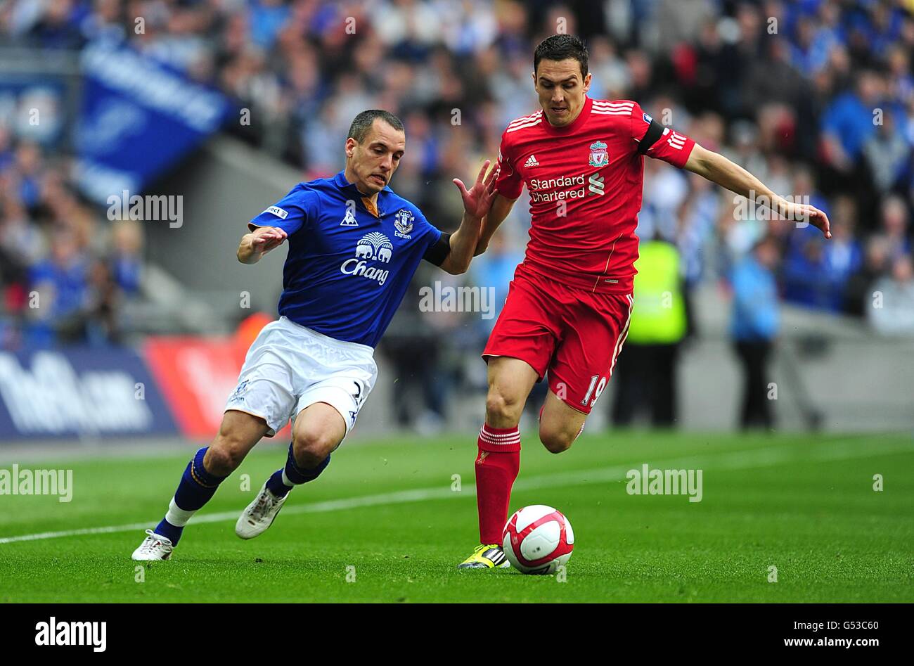Liverpool's Stewart Downing and Everton's Leon Osman (left) battle for ...