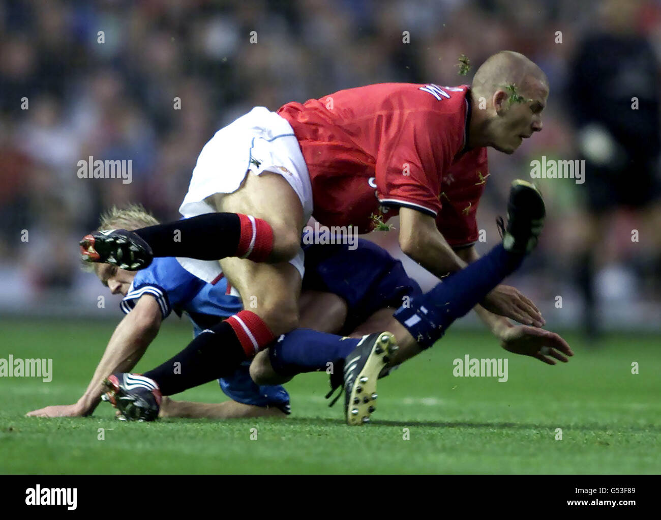 Manchester United's David Beckham is sent tumbling by Manchester City's ...