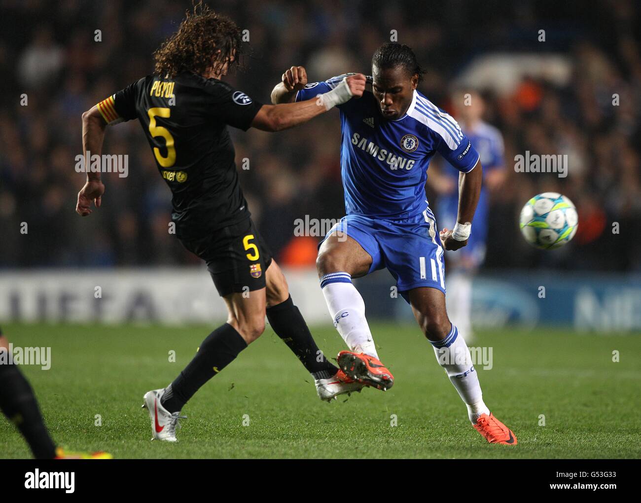 Chelseas didier drogba left and barcelonas carles puyol in action hi ...