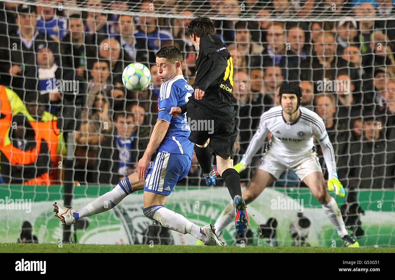 Barcelona's Lionel Messi (centre) has a shot blocked by Chelsea's Gary ...