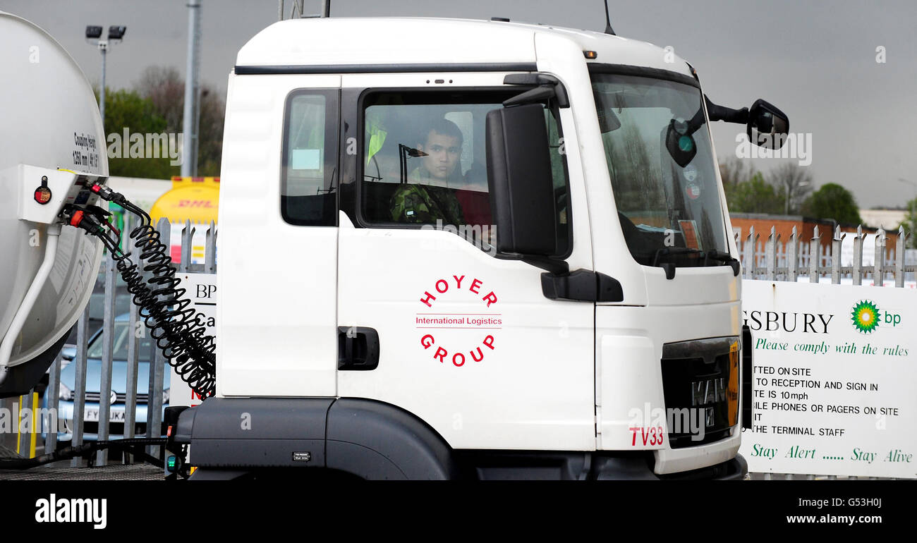 A man in a military uniform drives a petrol tanker at Kingsbury Depot ...