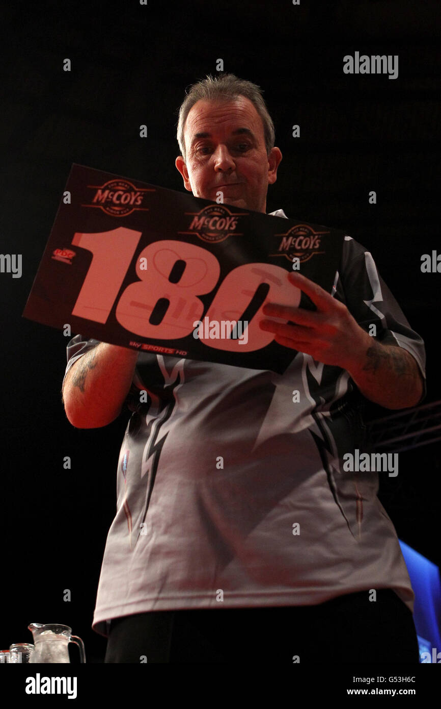 Phil Taylor signs autographs for fans after his match Stock Photo - Alamy