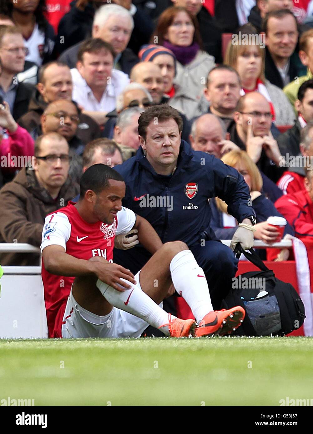 Arsenals theo walcott receives treatment on an injury hi-res stock ...