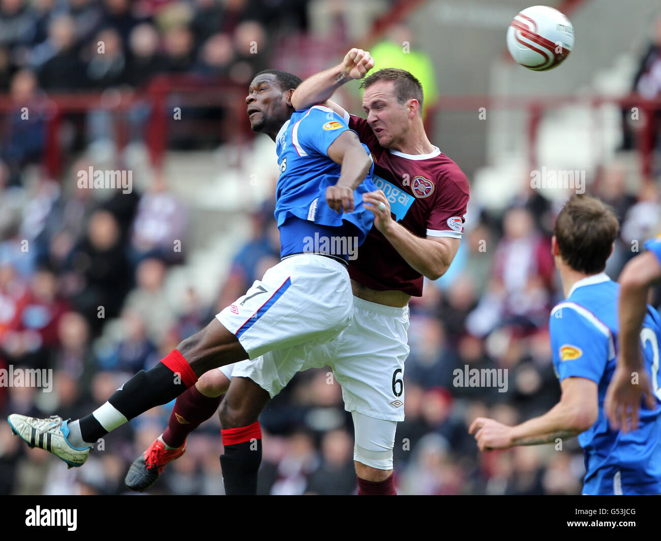 Hearts' Andy Webster challenges Rangers' Maurice Edu (left) during the ...