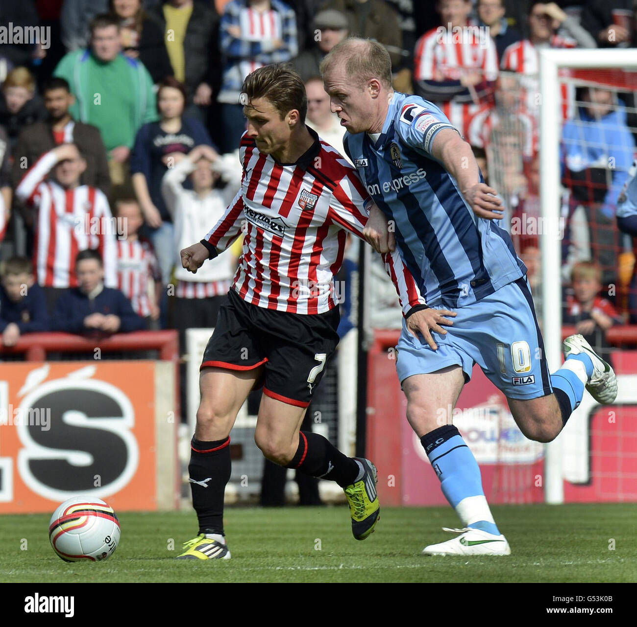 Brentford's Sam Saunders and Notts County's Neal Bishop (right) battle ...