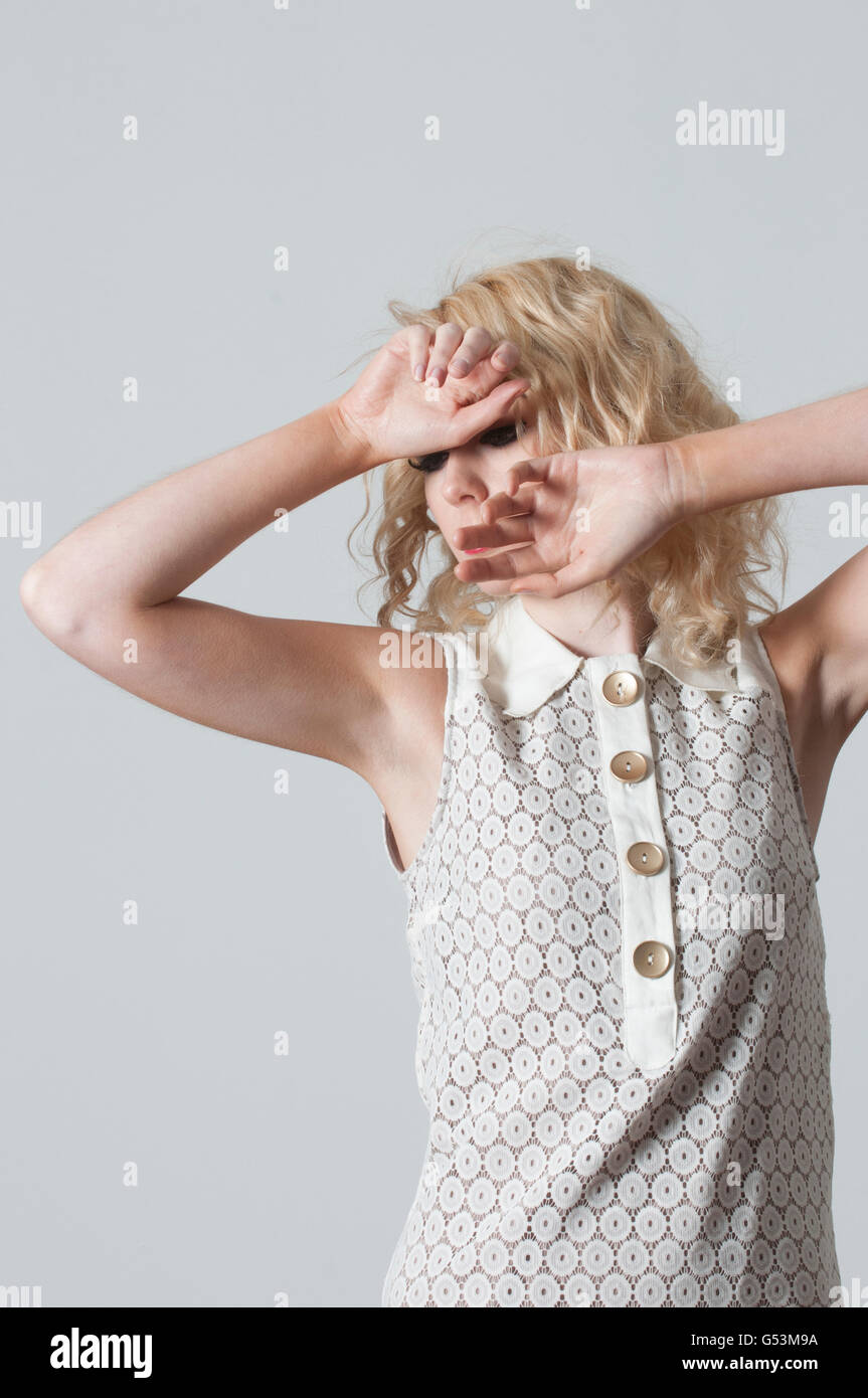 Young woman hiding face with hands Stock Photo - Alamy