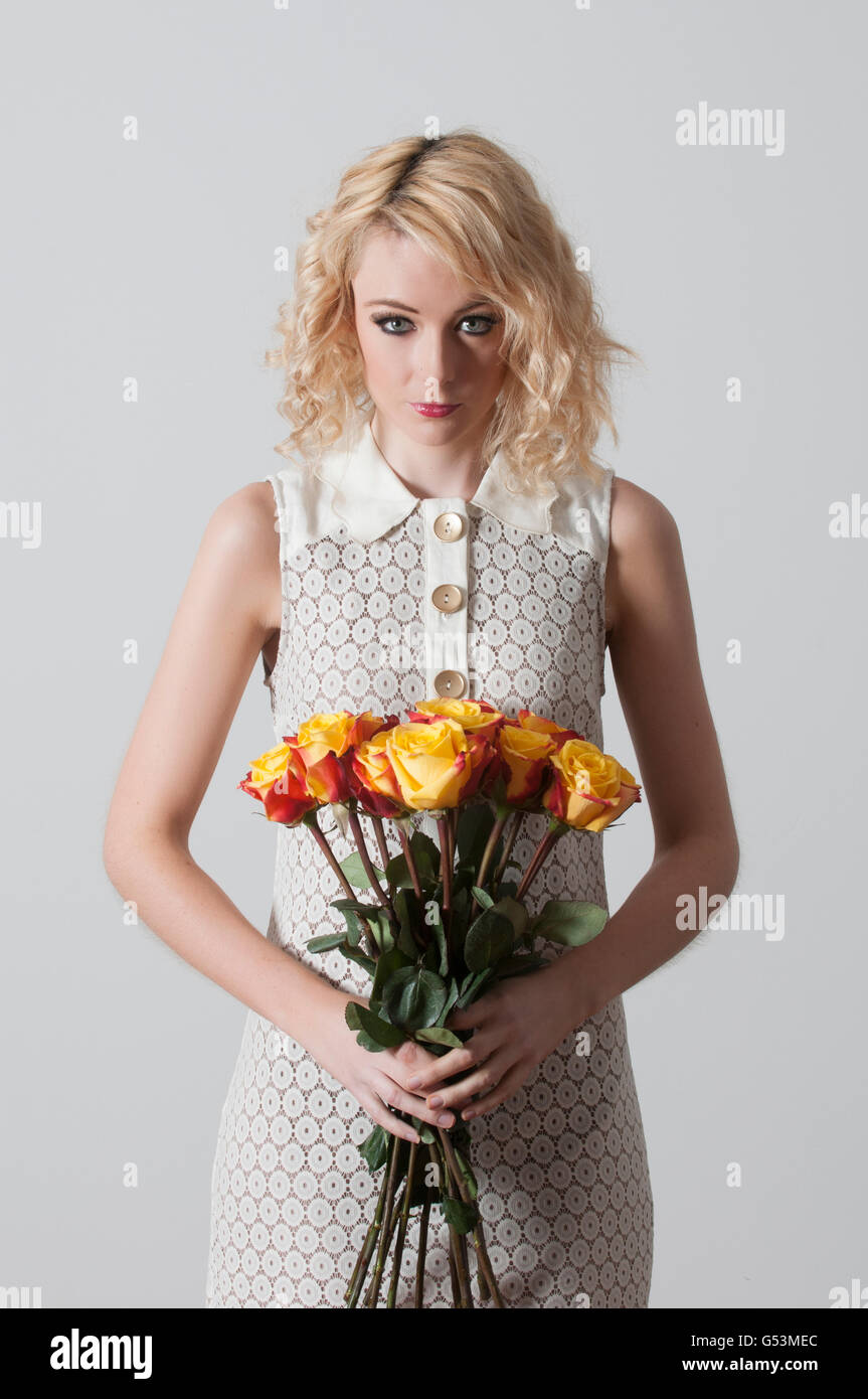 Beautiful woman holding roses Stock Photo - Alamy