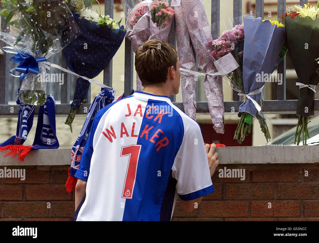 A Blackburn Rovers fan at Ewood Park pays his respects to the club's ...