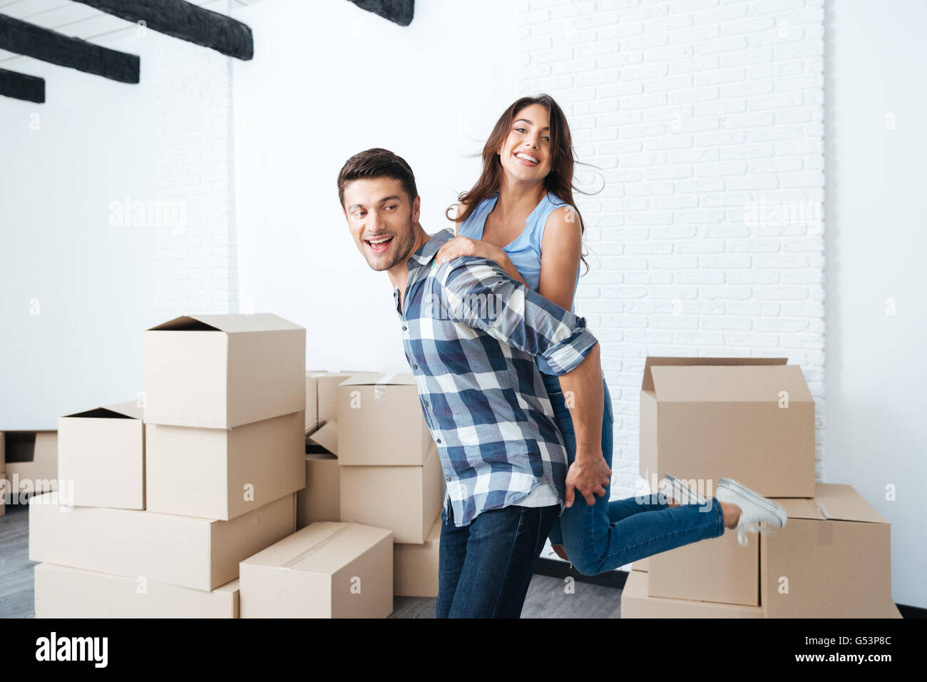 Young happy couple moving in new house Stock Photo - Alamy