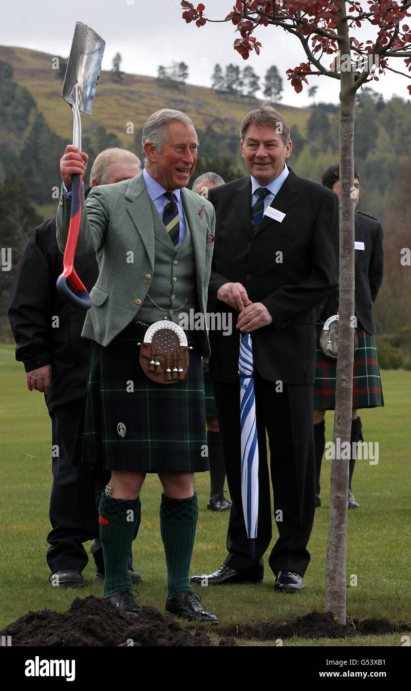 The Duke of Rothesay holds a spade after planting a tree at Ballater ...