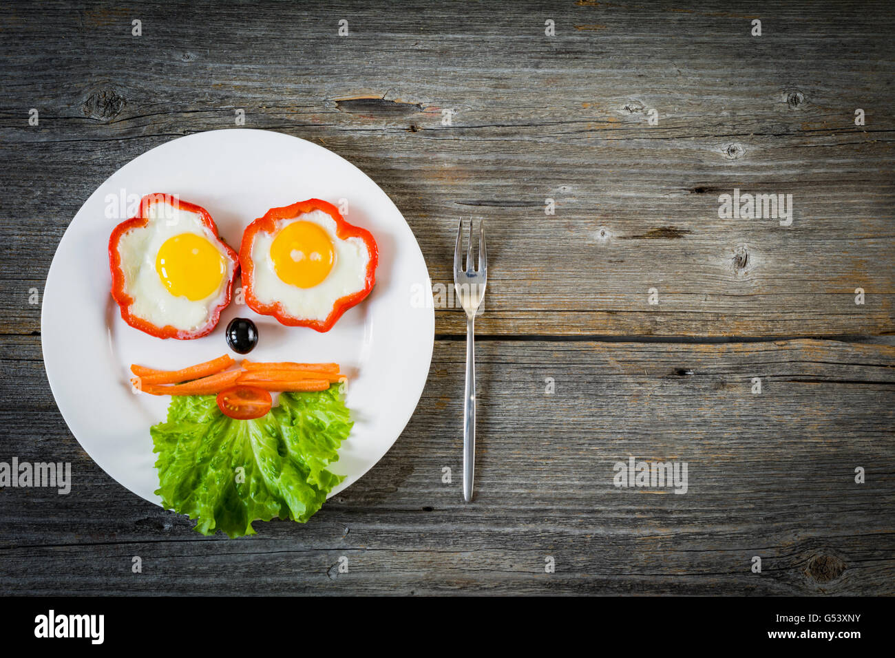 Eggs breakfast for kids. Colorful funny face on plate breakfast for ...