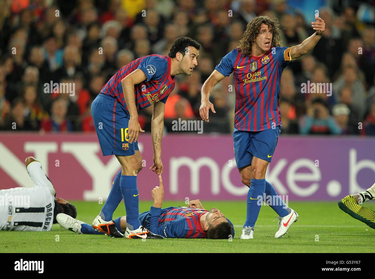 Barcelona's Gerard Pique lies injured on the ground after a clash with ...