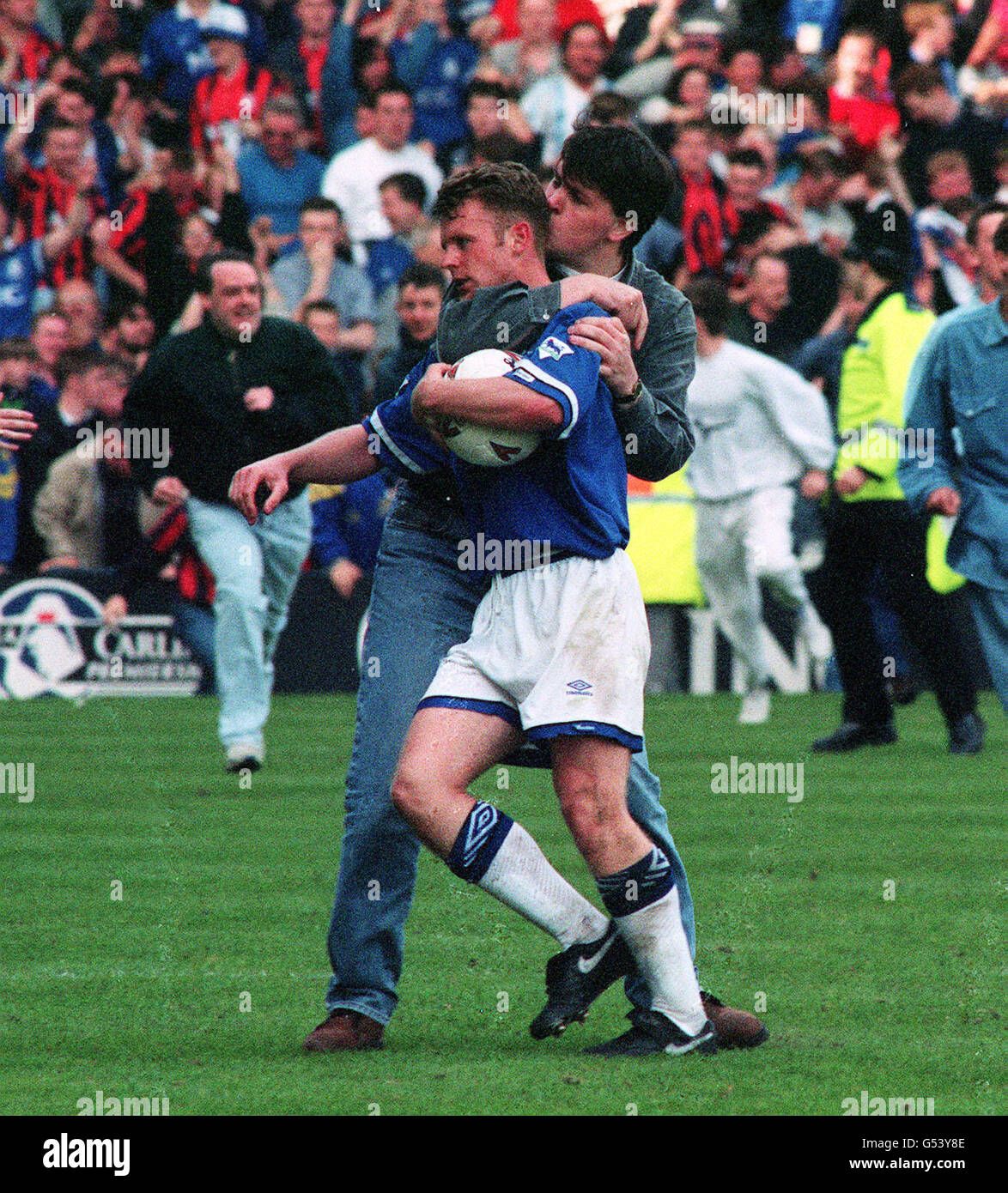 Everton hero Graham Stuart is kissed by a fan as he runs from the pitch ...