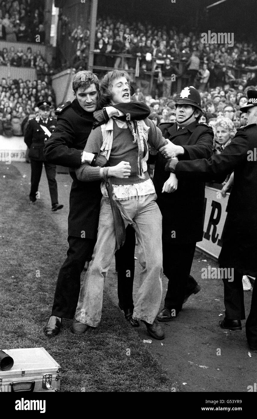 FOOTBALL HOOLIGANISM 1975: A policeman snaps an armlock on a fan at ...