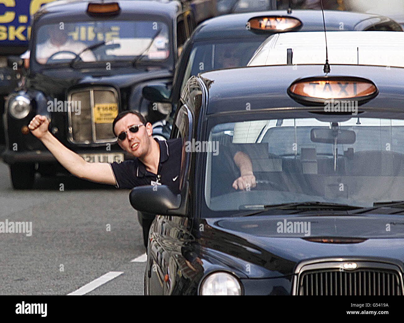 A Liverpool taxi driver salutes his colleagues on a go slow around ...