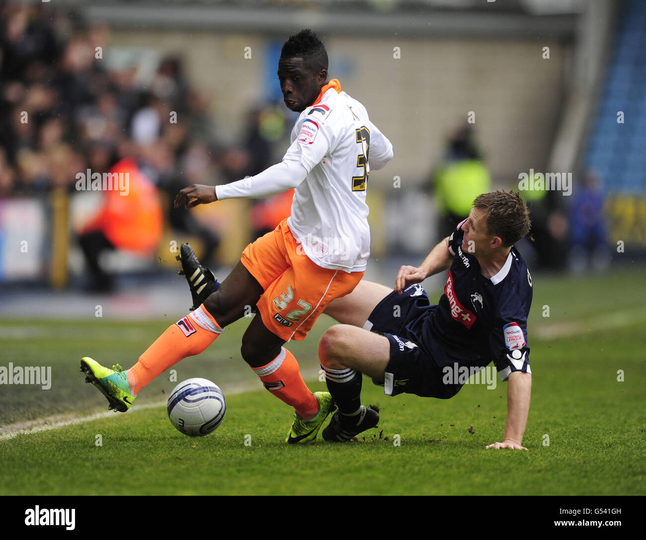 Millwall's Tony Craig (right) and Blackpool's Nouha Dicko battle for ...