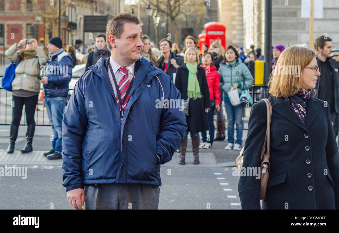 People walking across a road while commuting to work in London, England ...