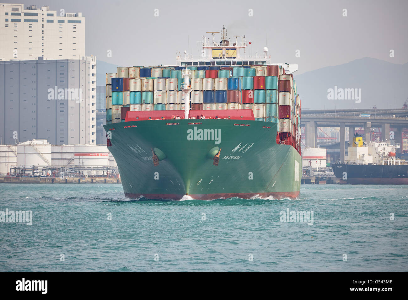 A laden container ship sailing away from the container terminals at ...