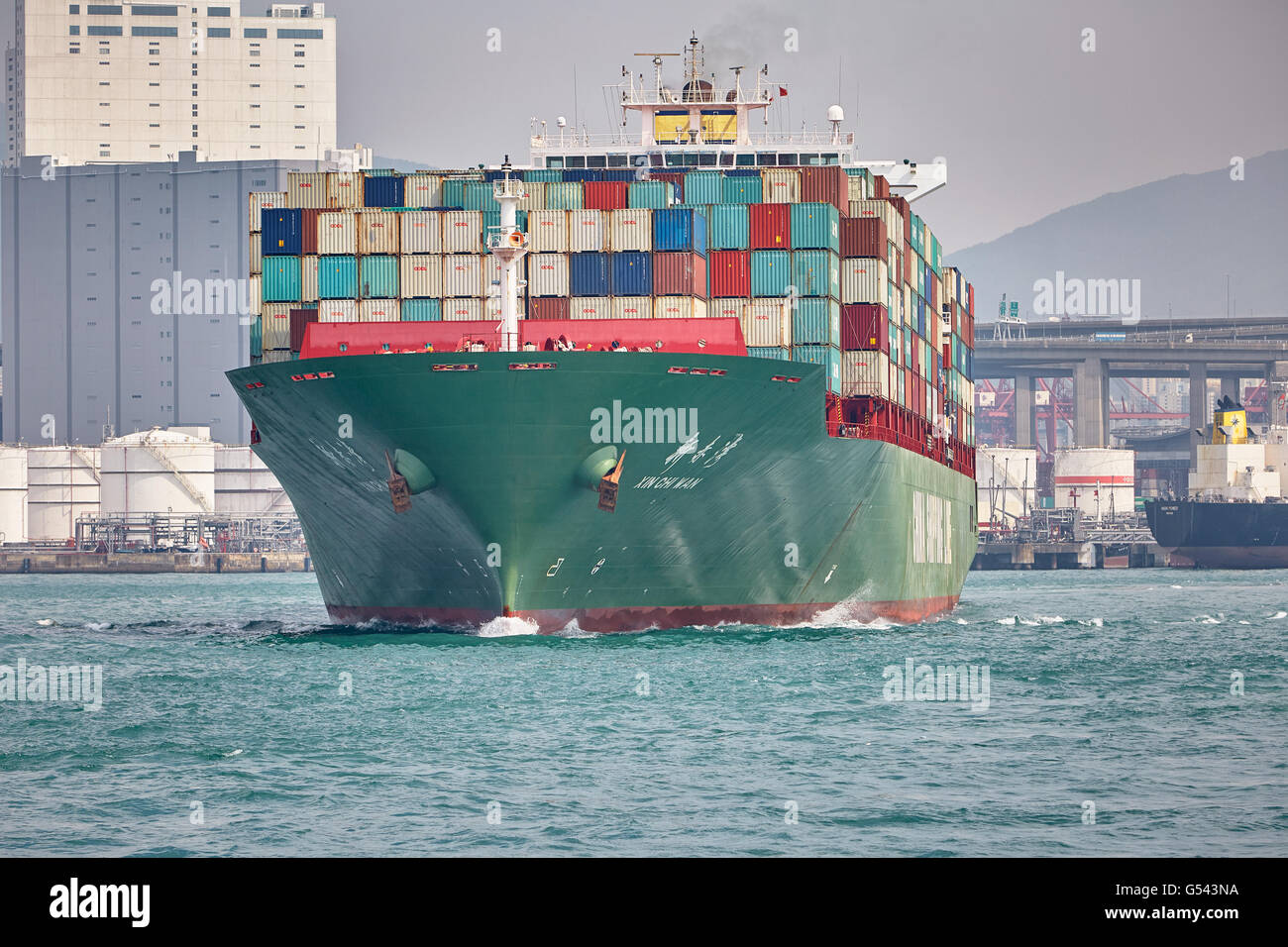 A laden container ship sailing away from the container terminals at ...