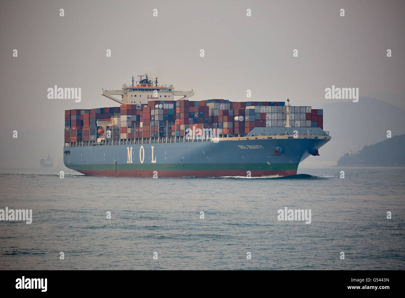 A laden container ship sailing up the East Lamma Channel off Hong Kong ...