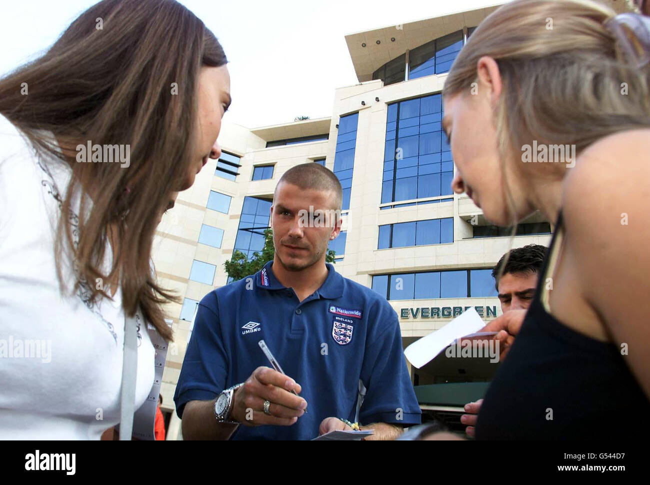 England's David Beckham signing autographs outside the team hotel after ...