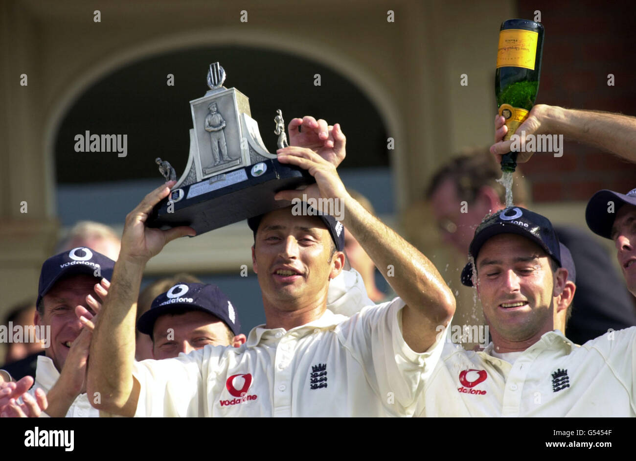 England Captain Nasser Hussain Holds The Wisden Trophy As Champagne Is Poured On Graham Thorpe