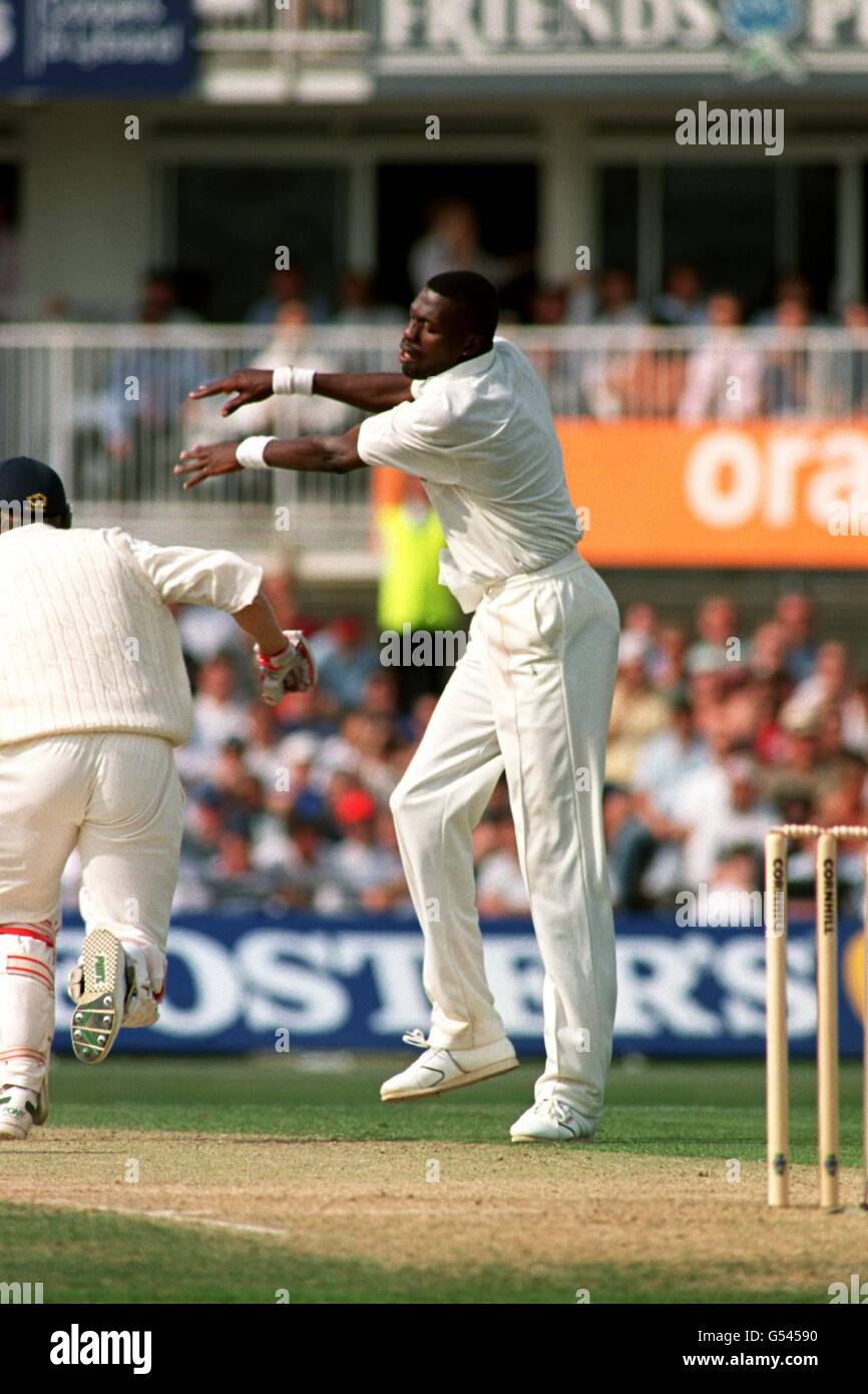 AN ANGRY CURTLEY AMBROSE, WEST INDIES, PUSHES OVER DOMINIC CORK ...