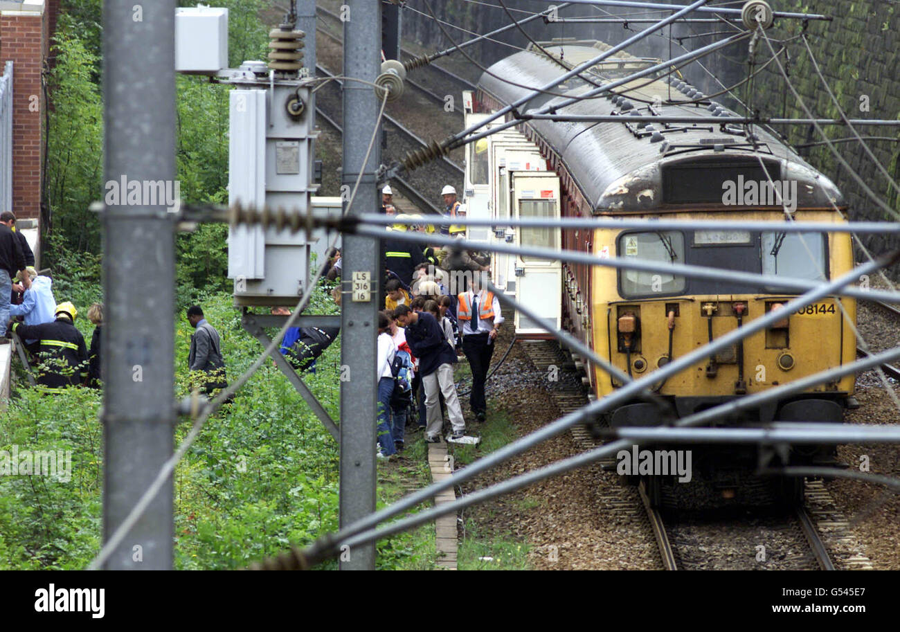 Passengers are evacuated from a train after the middle carriage of the ...