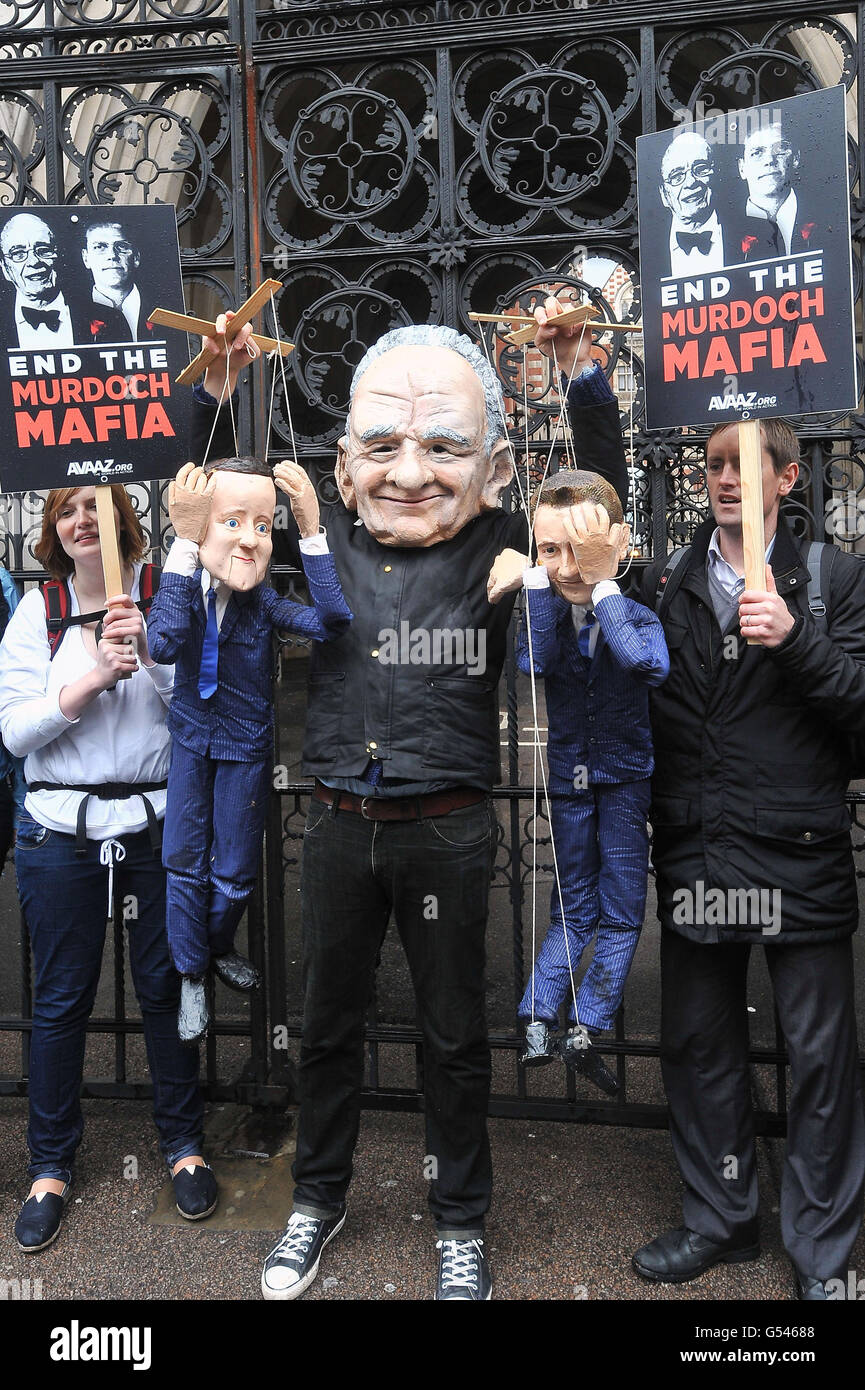 Campaigners from the organisation Avaaz protest with puppets of David ...